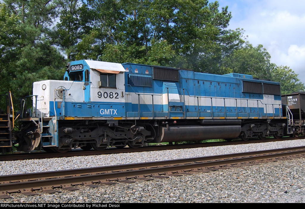 GMTX SD-60 #9082 is second out on an eastbound coal train about to cross Main St.